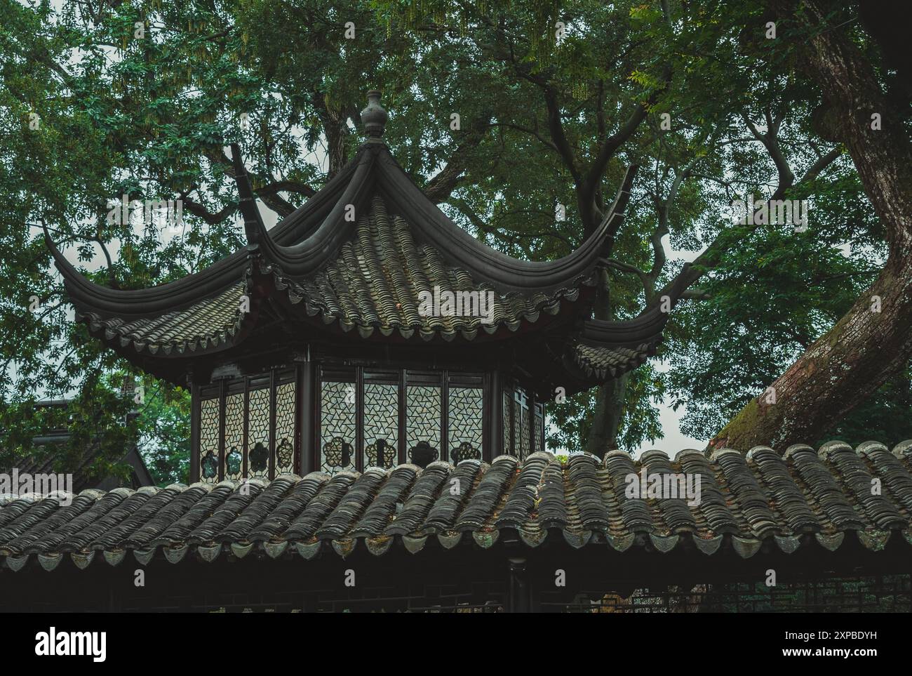 A traditional Chinese garden pavilion with a curved roof in Suzhou ...
