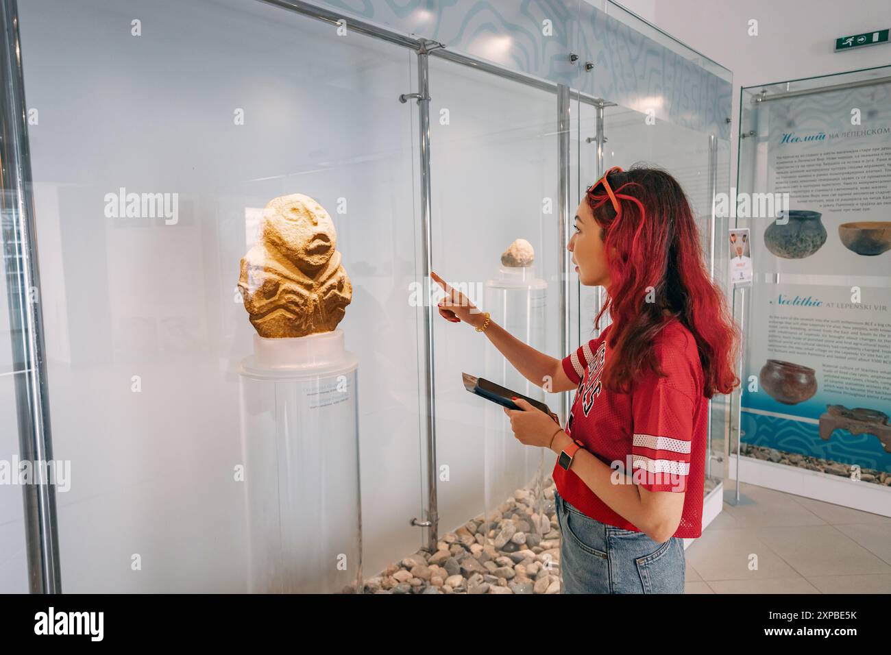 09 June 2024, Boljetin, Serbia: Tourist observing a display of ancient ... 09 June 2024, Boljetin, Serbia: Tourist observing a display of ancient ...