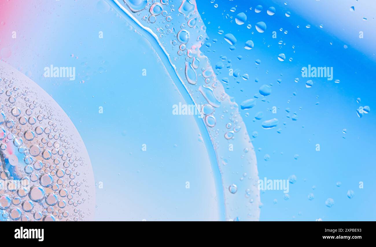 Close-up of blue liquid with bubbles and droplets, creating an abstract ...