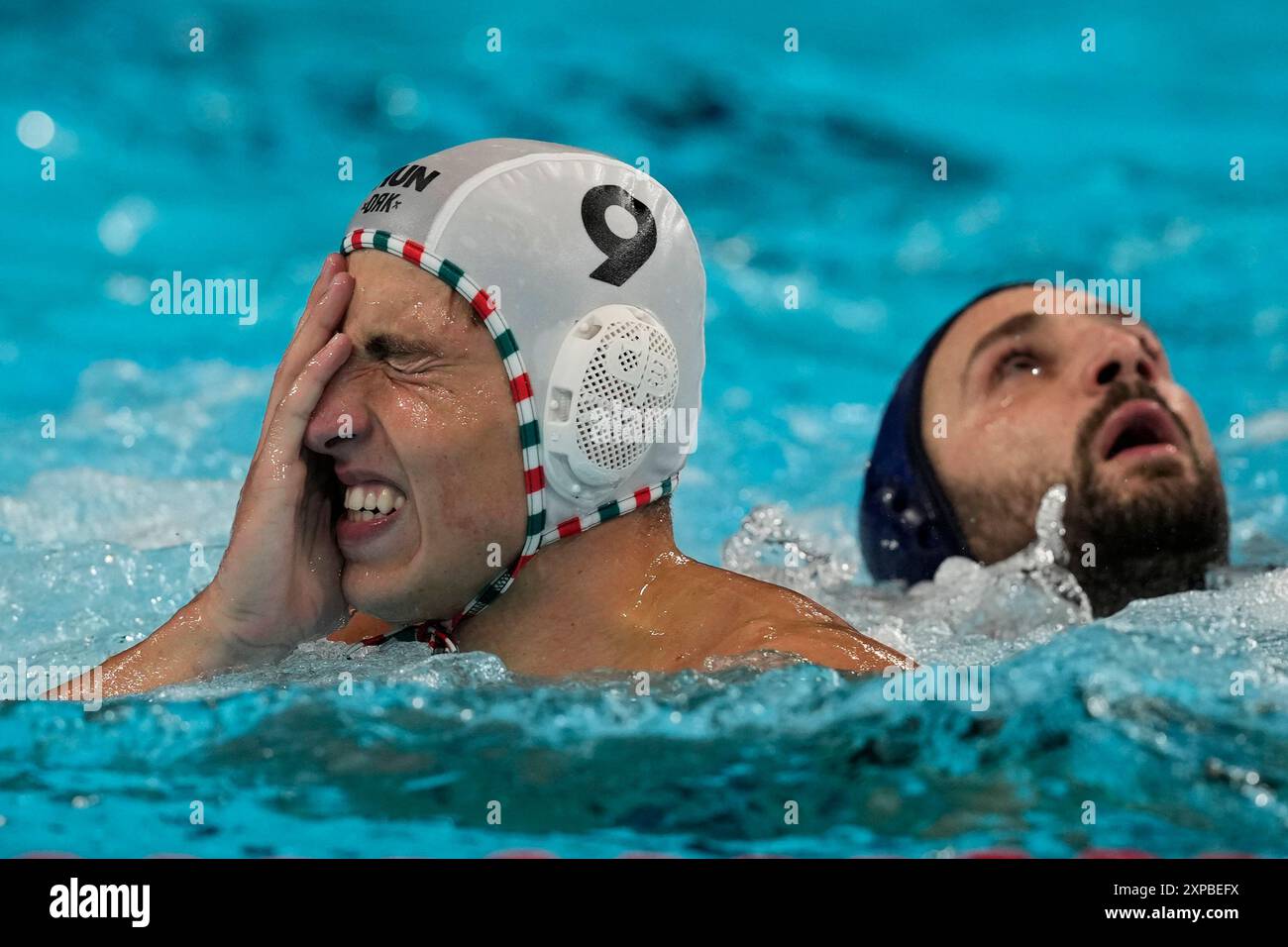 Hungary's Vince Pal Vigvari grimaces in pain after being hit in the ...