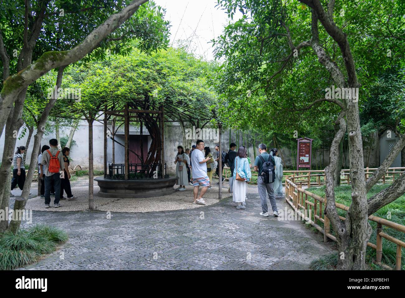 Suzhou, China - June 11, 2024 : A group of people walk through a ...