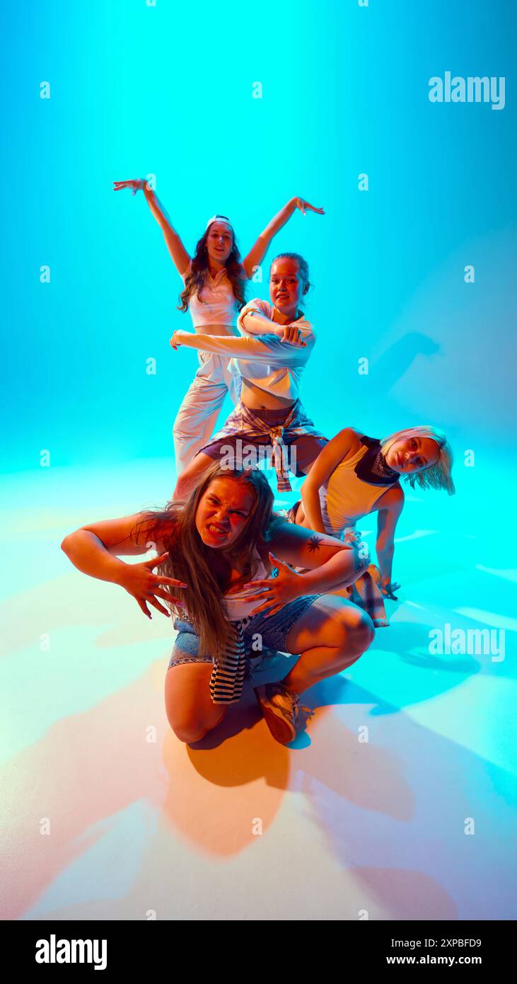 Lively group of dancers dressed in casual attire poses funny in vibrant ...