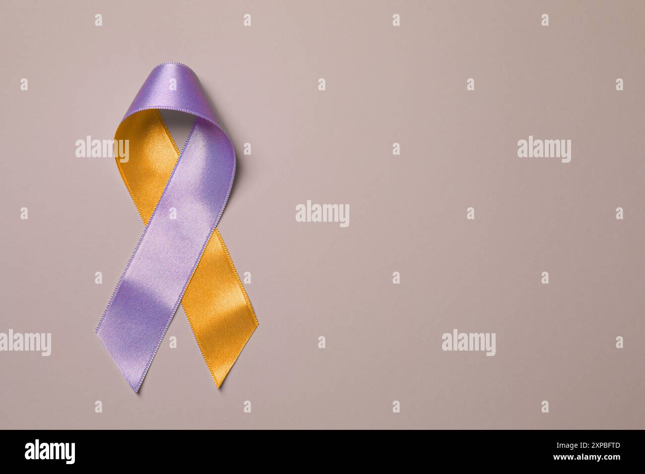 World Psoriasis Day. Orange and orchid awareness ribbon as symbol of ...