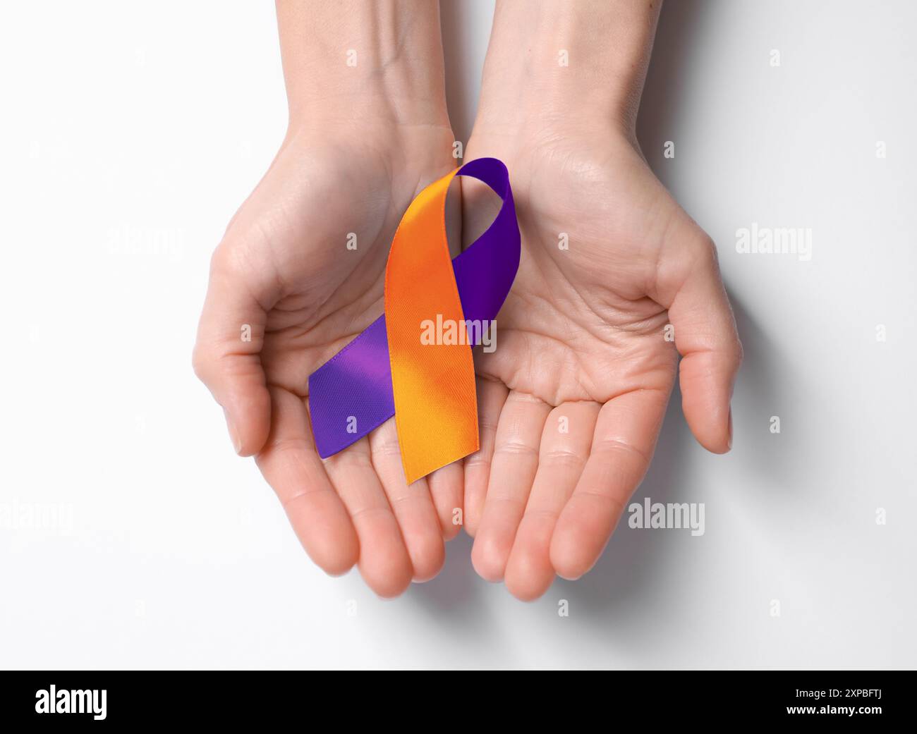 World Psoriasis Day. Woman with orange and orchid ribbon as symbol of ...