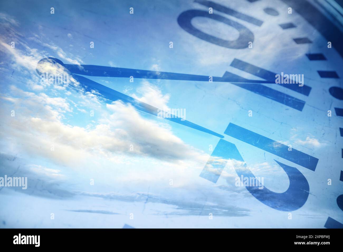 Time concept. Clock and blue sky with fluffy clouds, double exposure ...