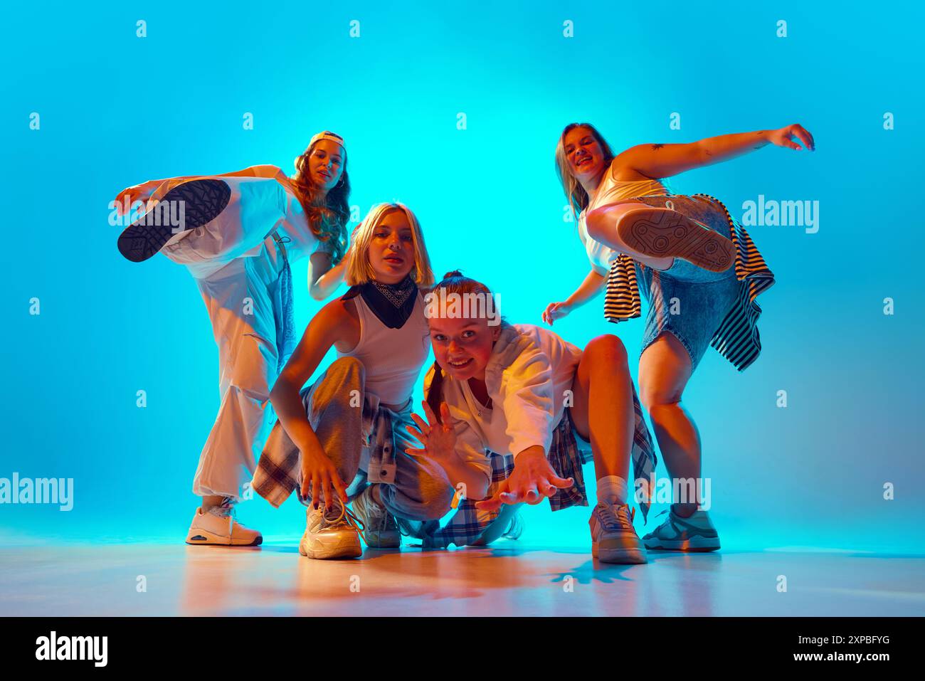 Group of funny dancers, dressed casually, perform bold and dynamic ...