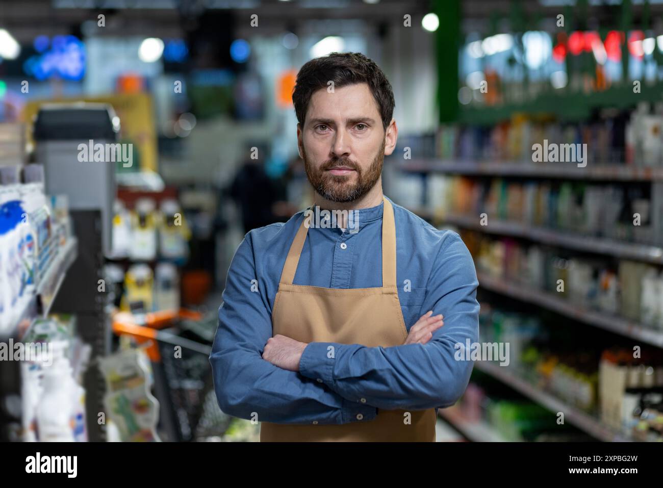 Serious supermarket manager arms crossed hi-res stock photography and ...