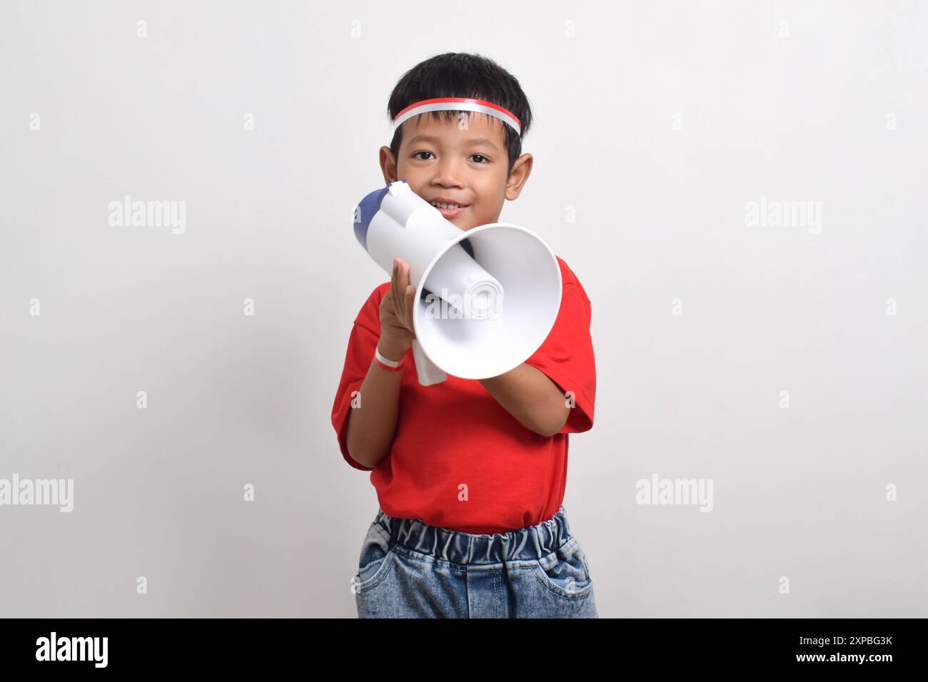 Excited Asian boy holding megaphone to speak, isolated on white ...