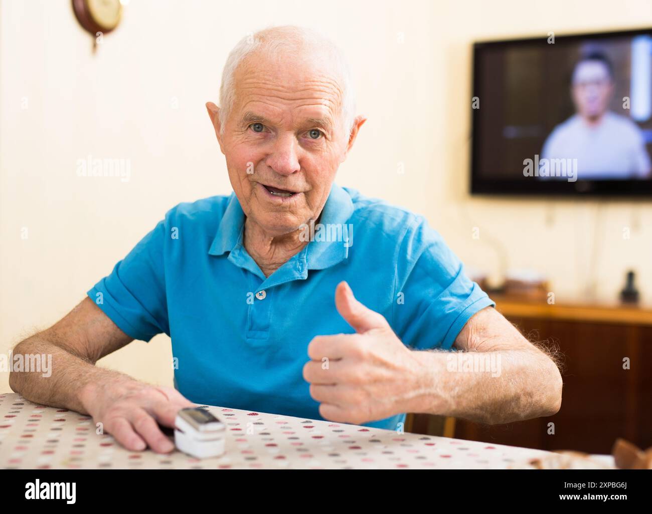 Happy senior man checking blood oxygen level with pulse oximeter Stock ...