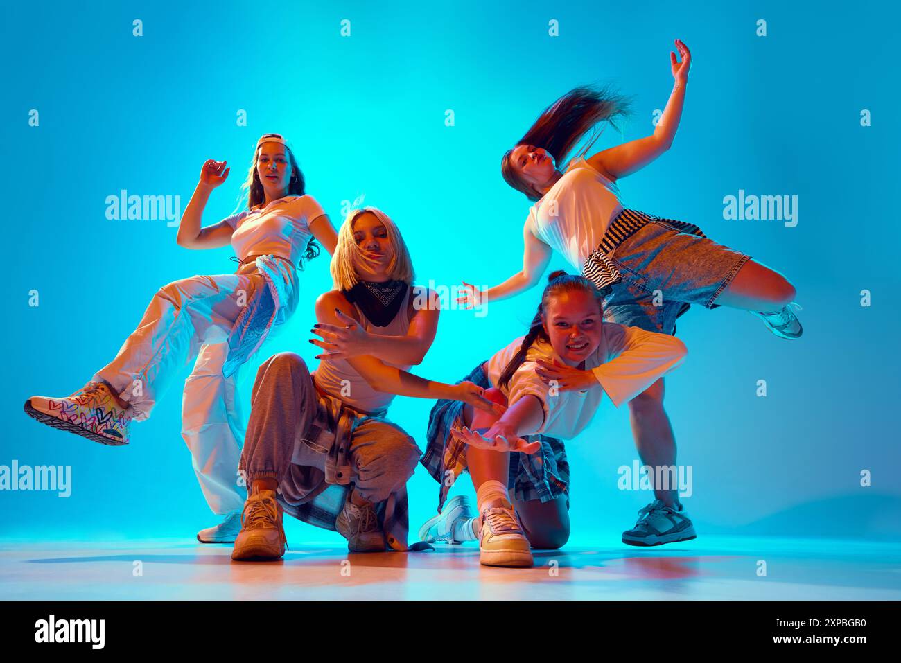 Friends, dancers, wearing streetwear, pose confidently and playfully ...