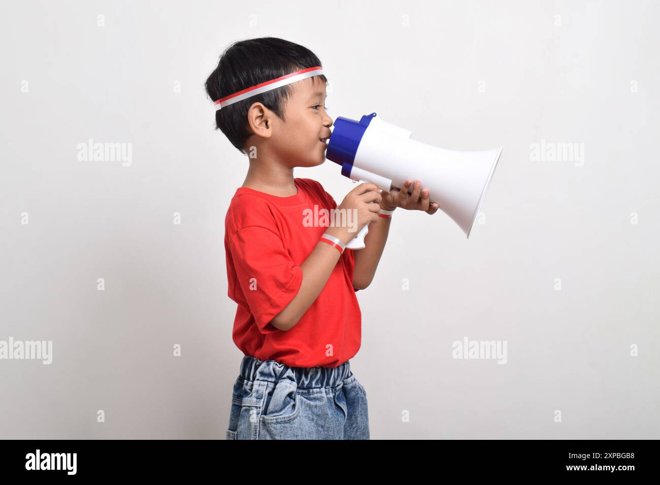 Excited Asian boy holding megaphone to speak, isolated on white ...