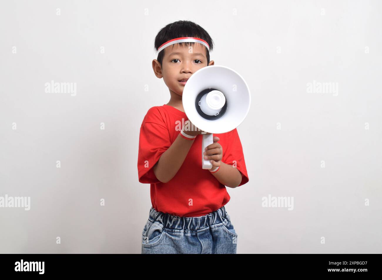Excited Asian boy holding megaphone to speak, isolated on white ...