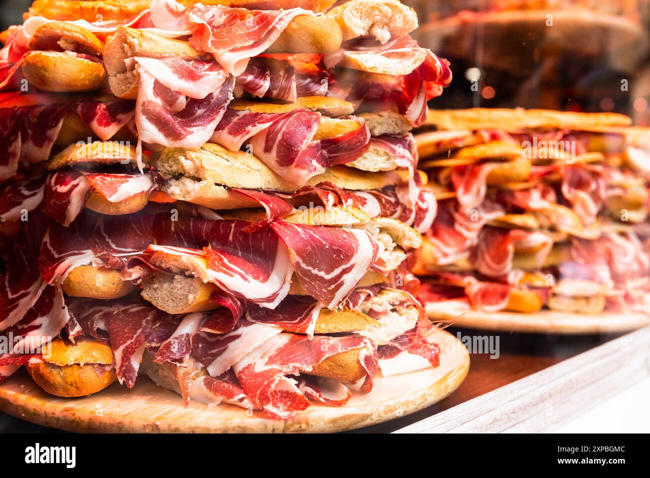 Traditional Spanish bocadillos with Iberico jamon laid out in a slide ...