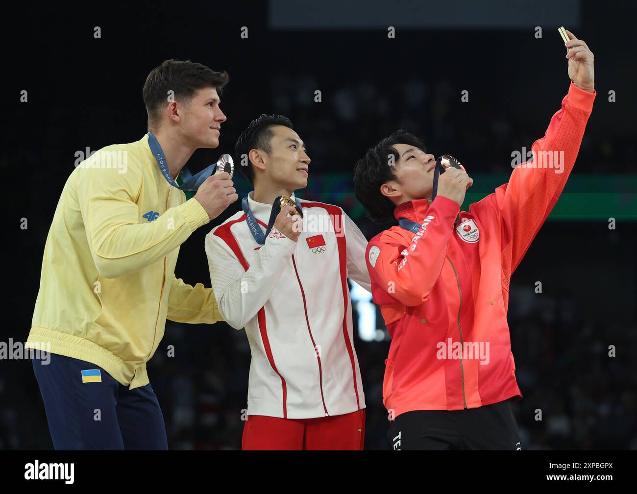Paris, France. 5th Aug, 2024. Gold medalist Zou Jingyuan (C) of China, silver medalist Illia ...