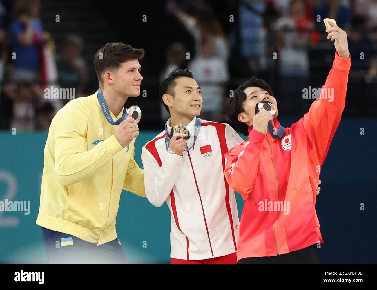 Paris, France. 5th Aug, 2024. Gold medalist Zou Jingyuan (C) of China, silver medalist Illia ...