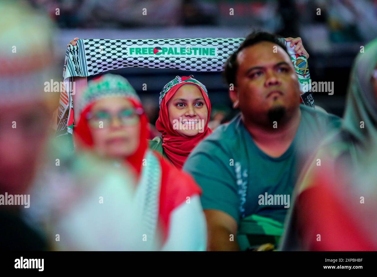 A woman holds a Free Palestine muffler during the liberation rally ...