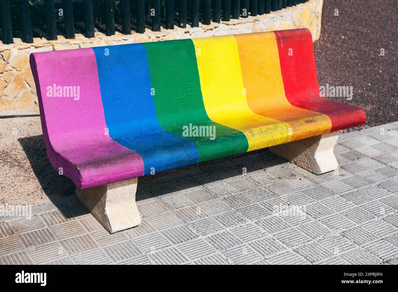 Bench with the colors of the rainbow painted on it. Wooden seat painted ...