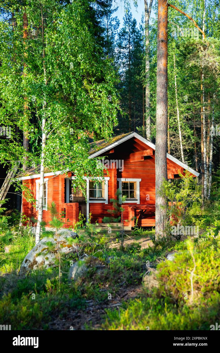 beautiful red cottage in middle of a forest in finland Stock Photo - Alamy