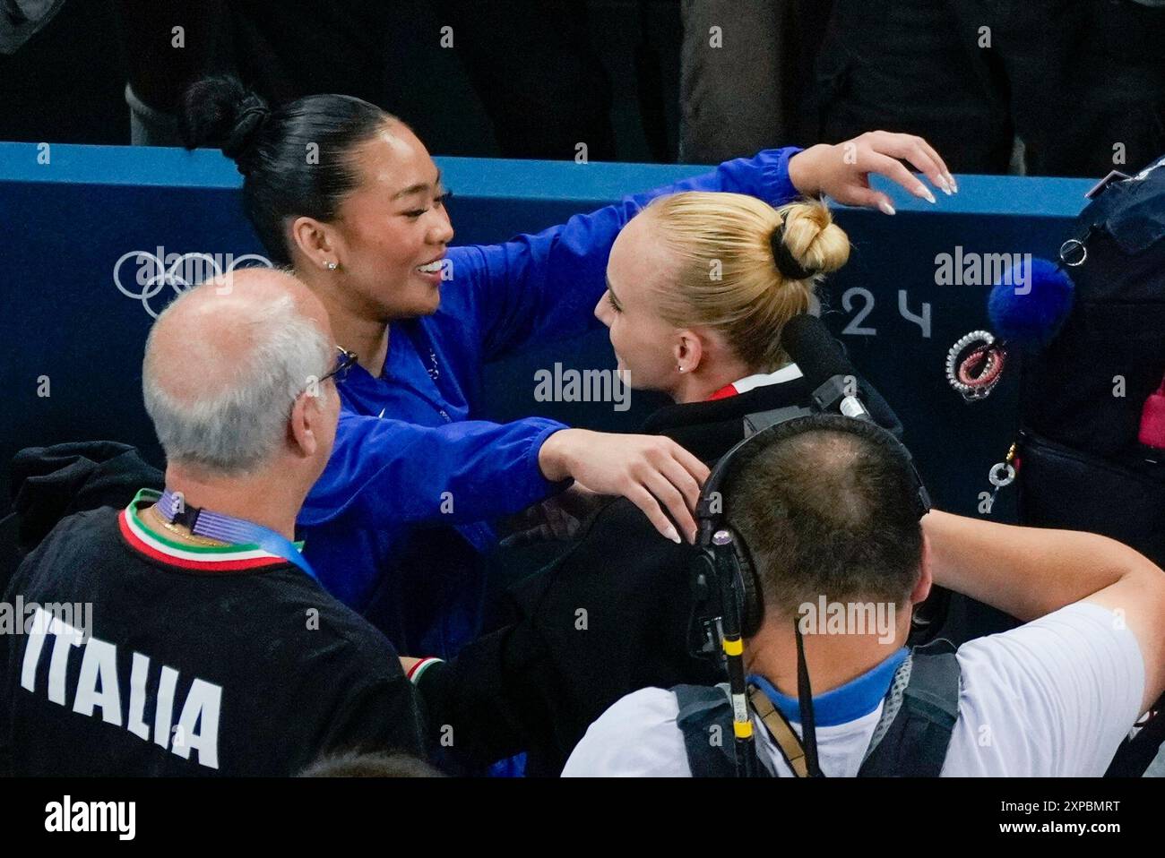 Alice D'Amato, of Italy, gets a hug from Suni Lee, of the United States ...