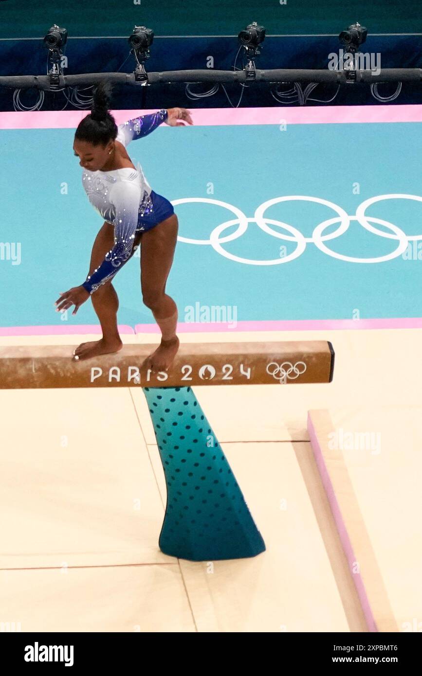 Simone Biles, of the United States, falls on the beam during the women ...