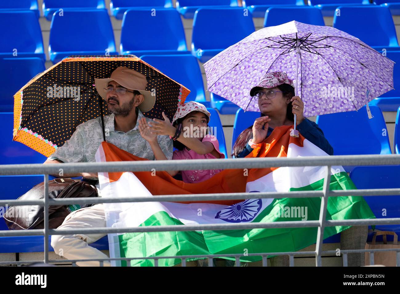 An Indian family watches the Skeet mixed team qualification round at ...