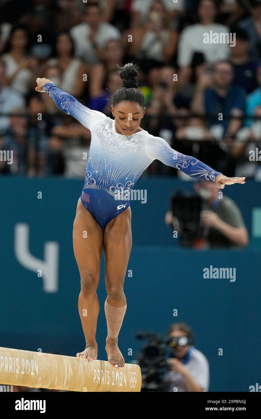 Simone Biles, of the United States, slips and falls during the women's ...