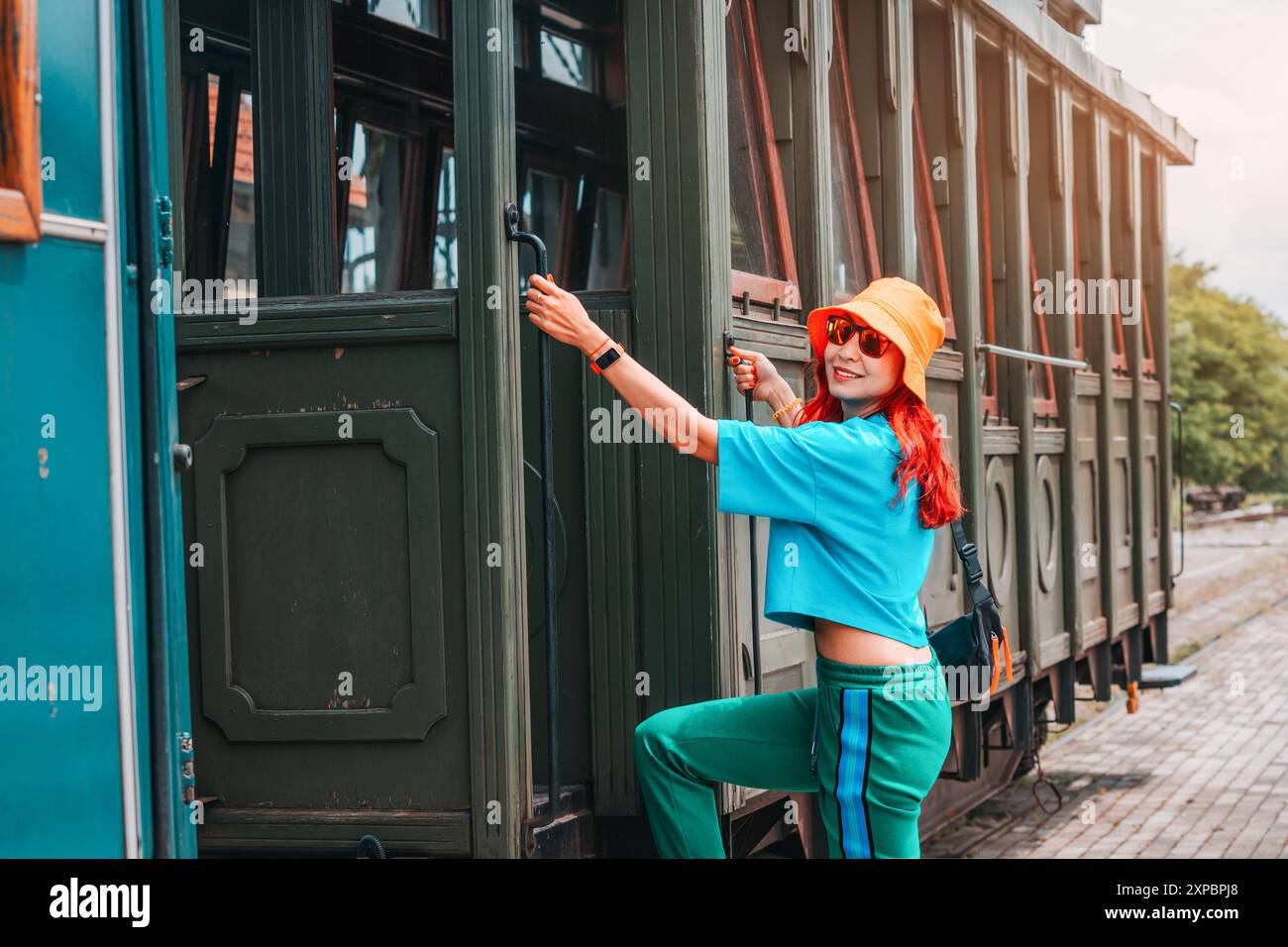 Happy passenger waving from a vintage train carriage on the Shargan ...