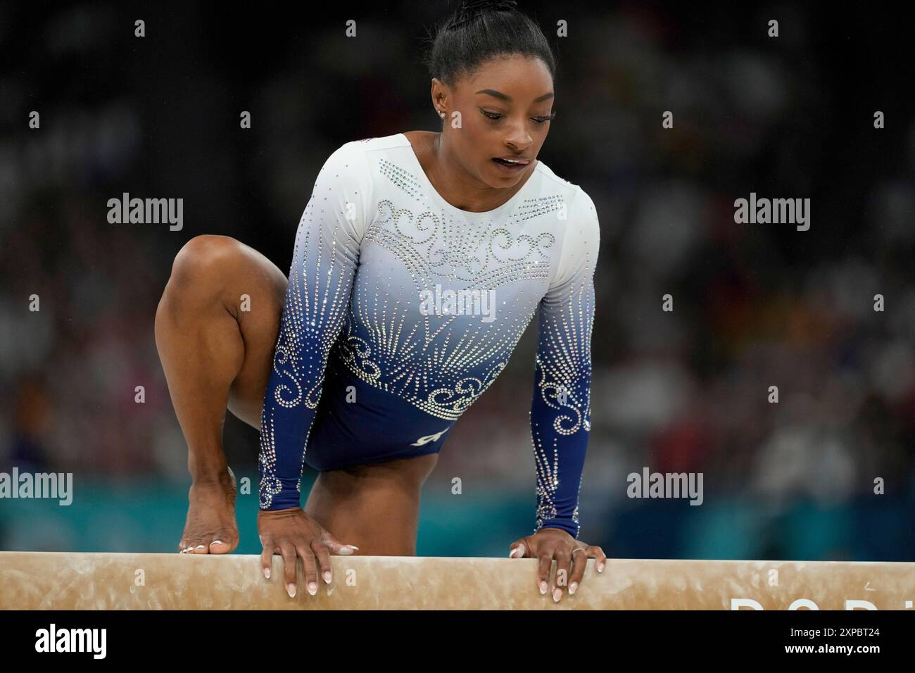 Simone Biles, of the United States, falls during the women's artistic ...