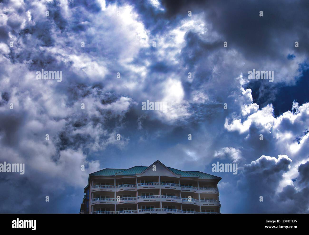 Top floors of an apartment building under a cloudy sky Stock Photo - Alamy