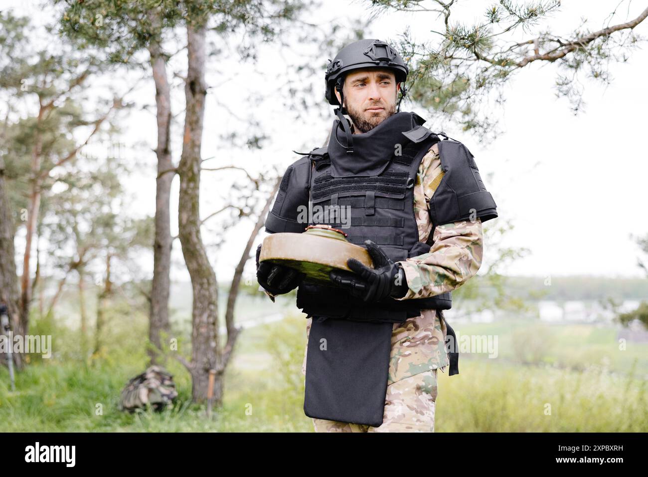 A man in a special suit works with a detector and found an explosive ...