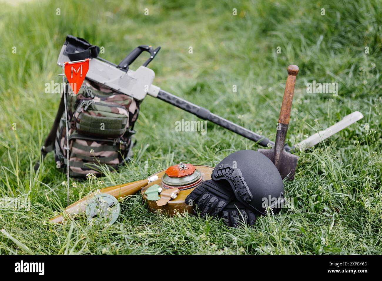 Explosive devices and a metal detector lie on the background of a ...