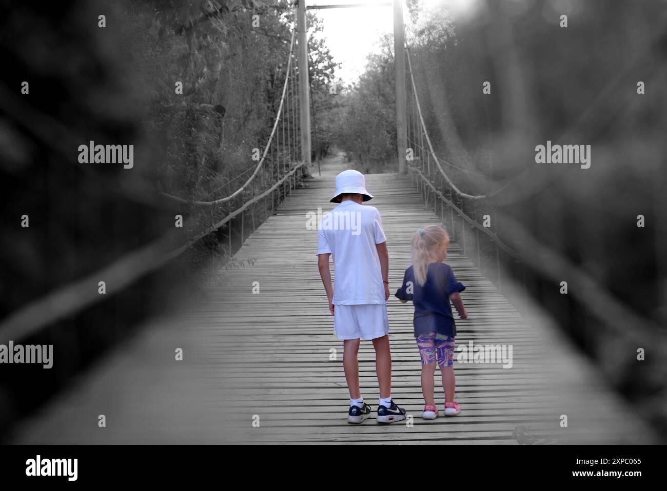 Children crossing rope bridge hi-res stock photography and images - Alamy