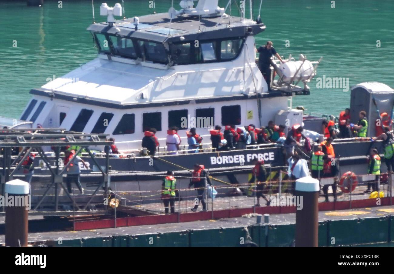 A group of people thought to be migrants are brought in to Dover, Kent ...