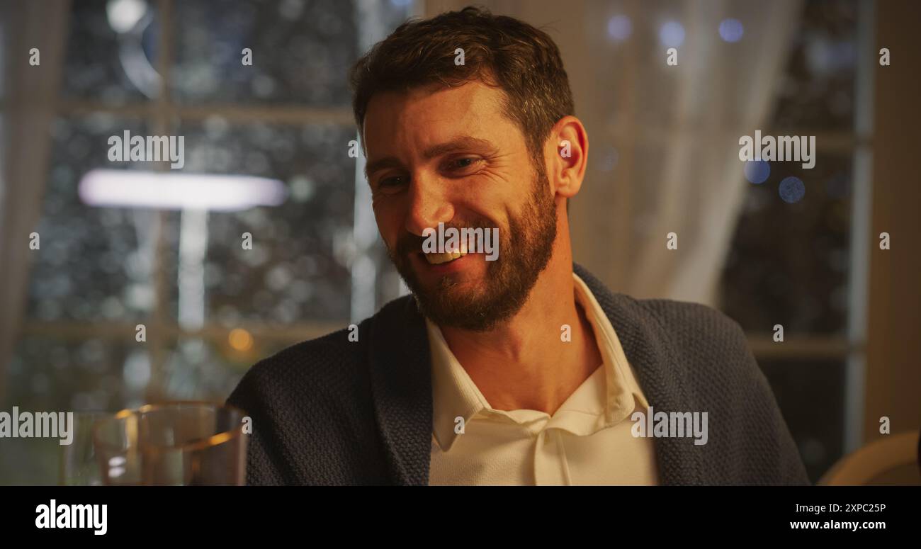 Handsome Man Sitting at a Festive Table with Family and Friends During ...