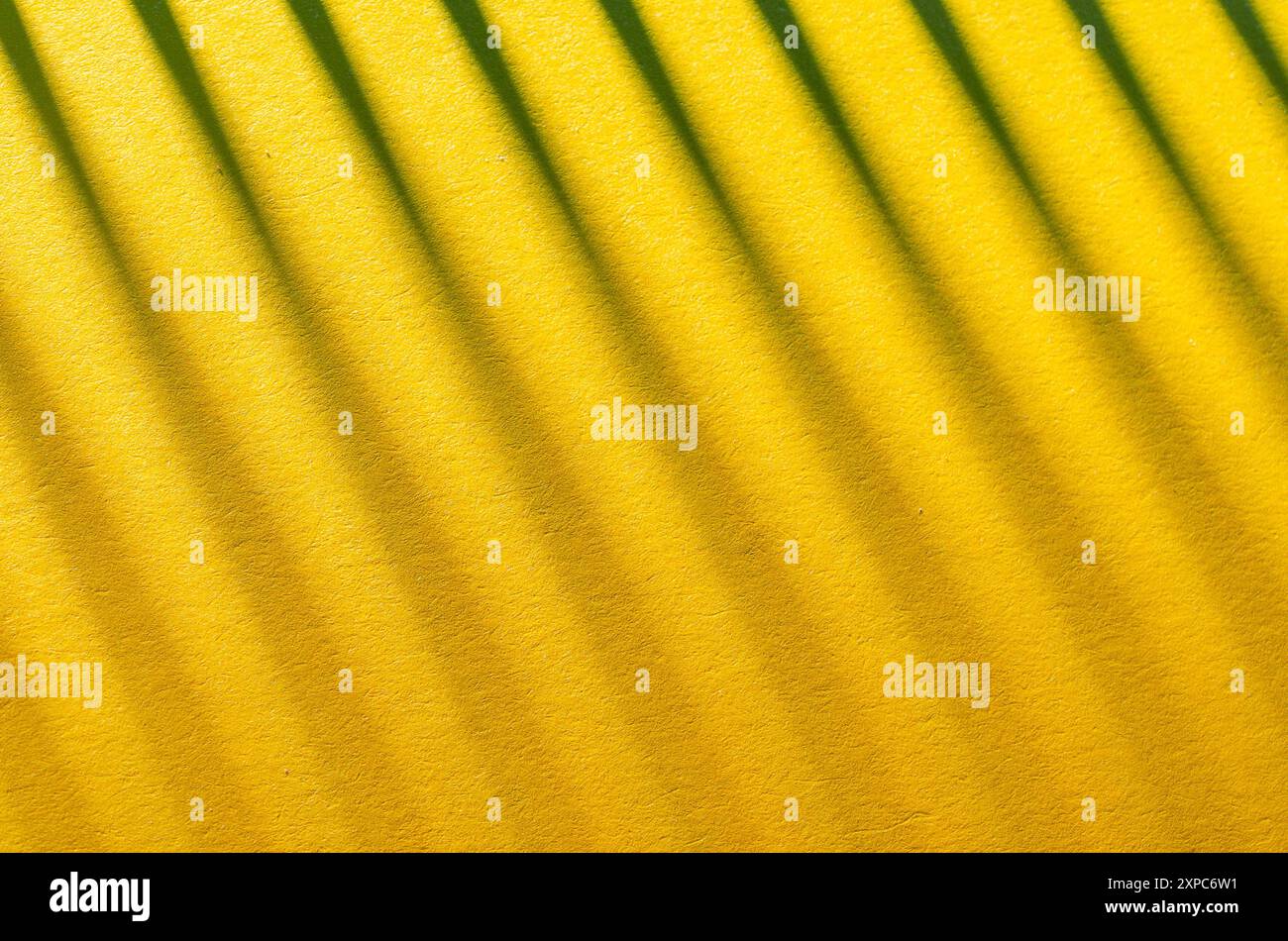 Abstract yellow background with diagonal lines drawn by shadows and ...