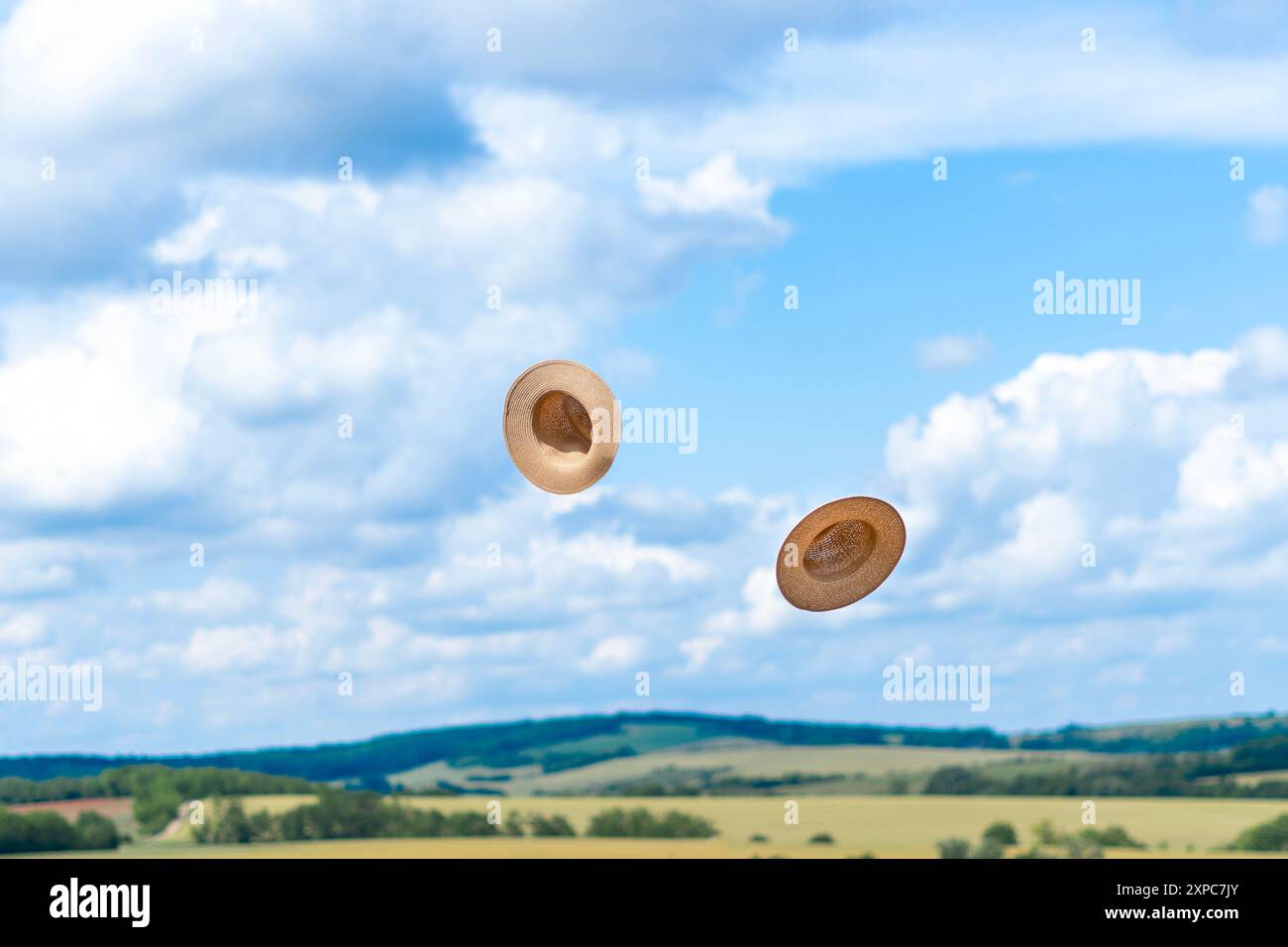 Straw hats flying in a blue sky Stock Photo - Alamy
