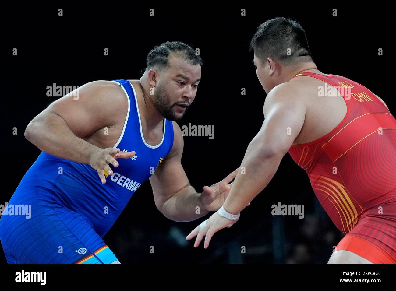 China's Meng Lingzhe and Germany's Jello Krahmer, left, compete in the round of 16 of the men's ...