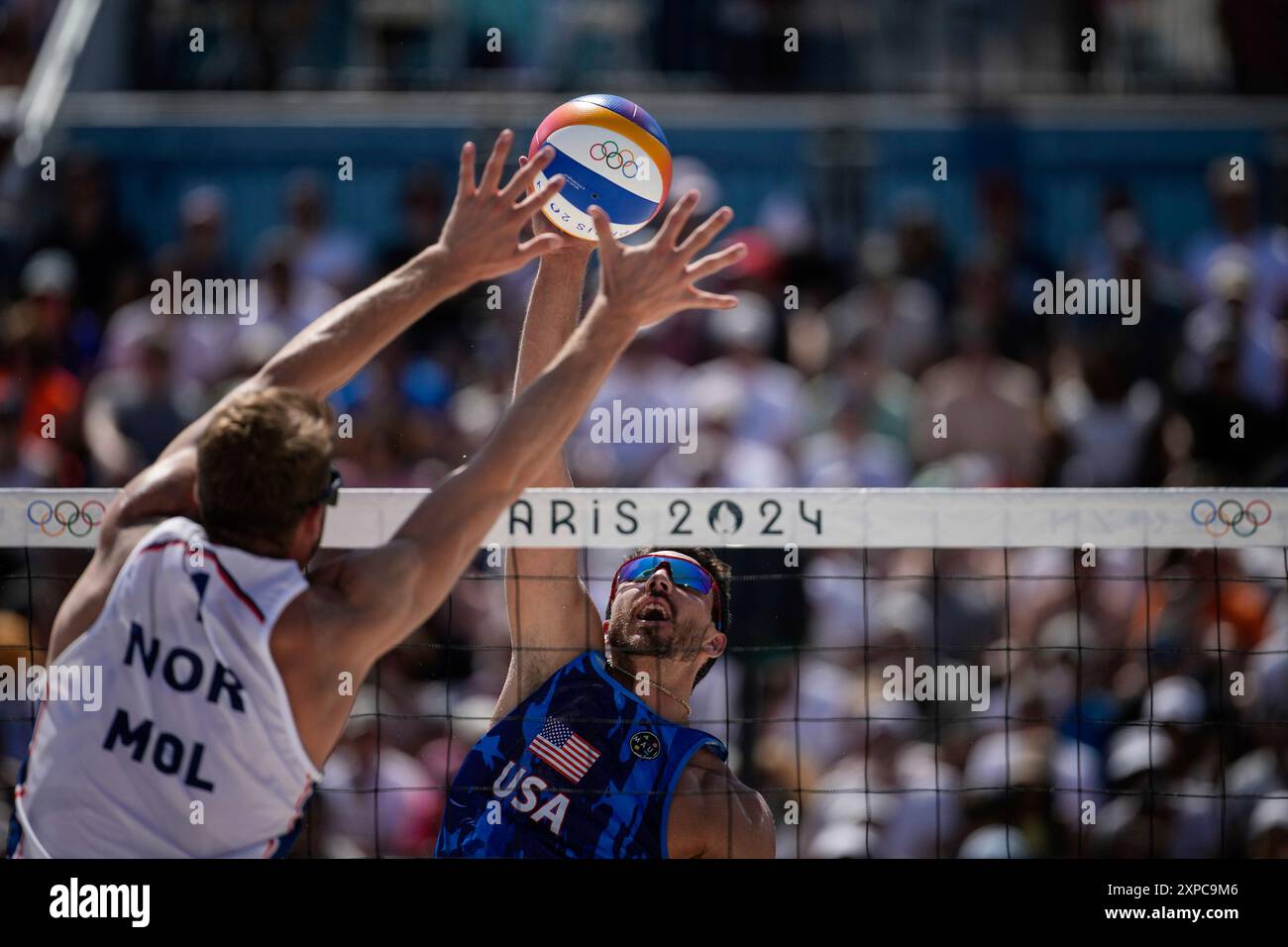 US' Miles Evans hits the ball during the men's round of 16 beach ...