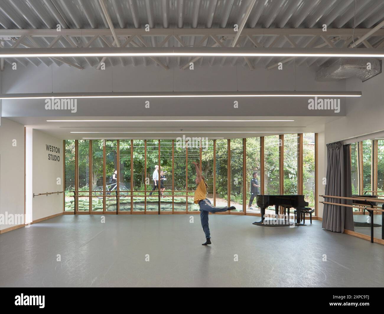 Studio interior with dancer, piano and fenestration. Rambert School of ...