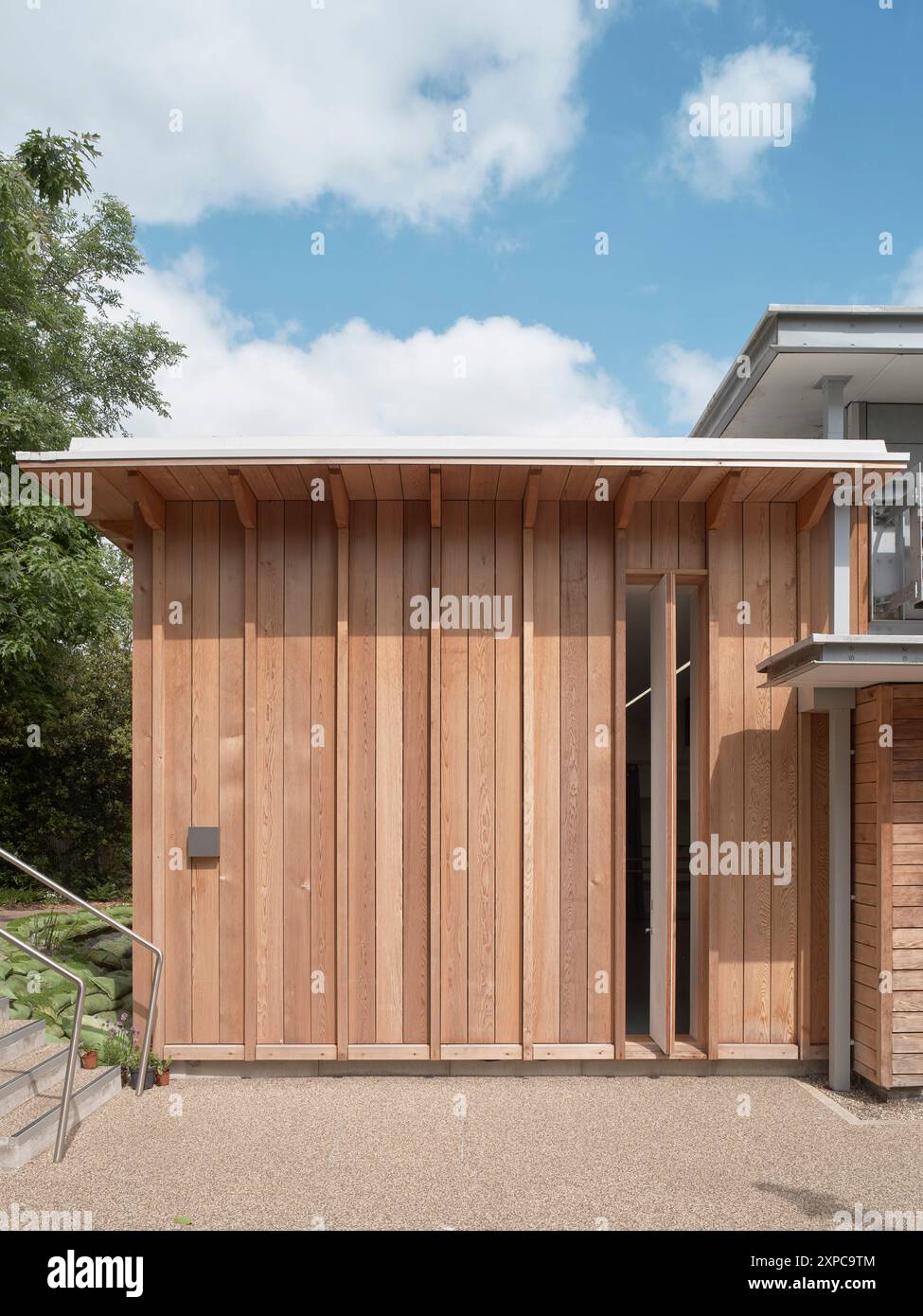 Timber facade on estate's grounds with pivoting ventilation slot ...