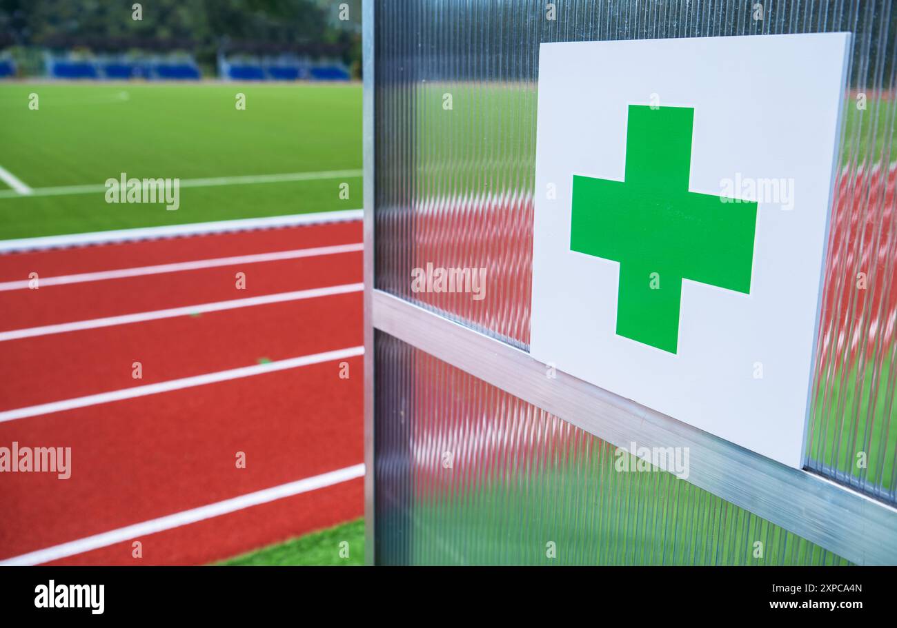 A first aid station is marked with a green cross, positioned next to a ...
