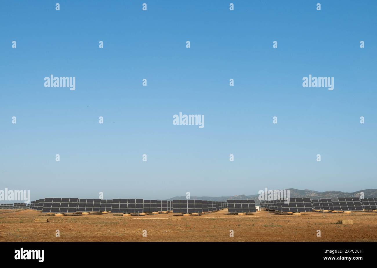 A large solar plant filled with photovoltaic solar panels receives ...