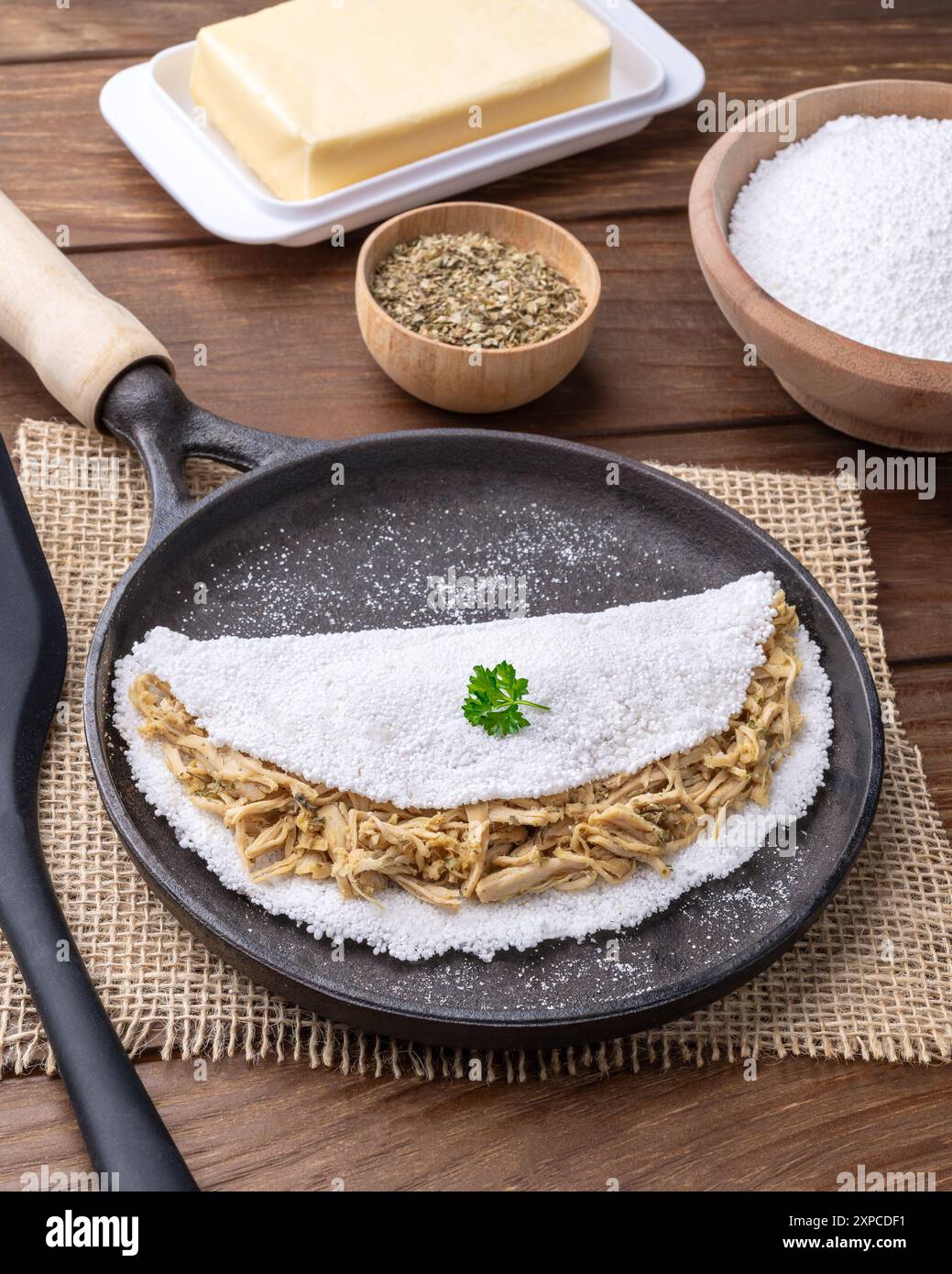 Traditional brazilian chicken stuffed tapioca on a pan with ingredients ...