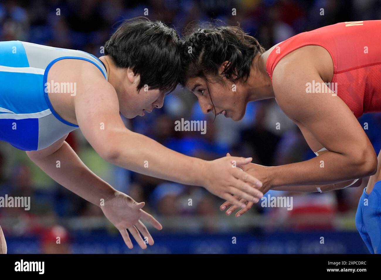 India's Nisha Nisha and North Korea's Sol Gum Pak, left, compete during ...