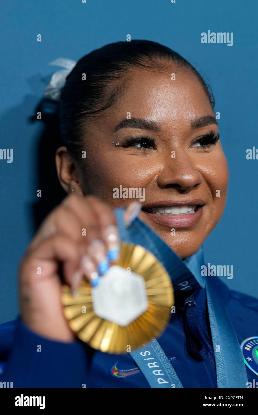 Jordan Chiles, of the United States, holds up her medals after the ...