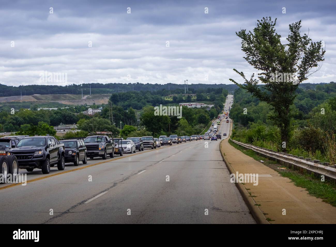 The cars with heavy traffic on the American highway in the middle of ...