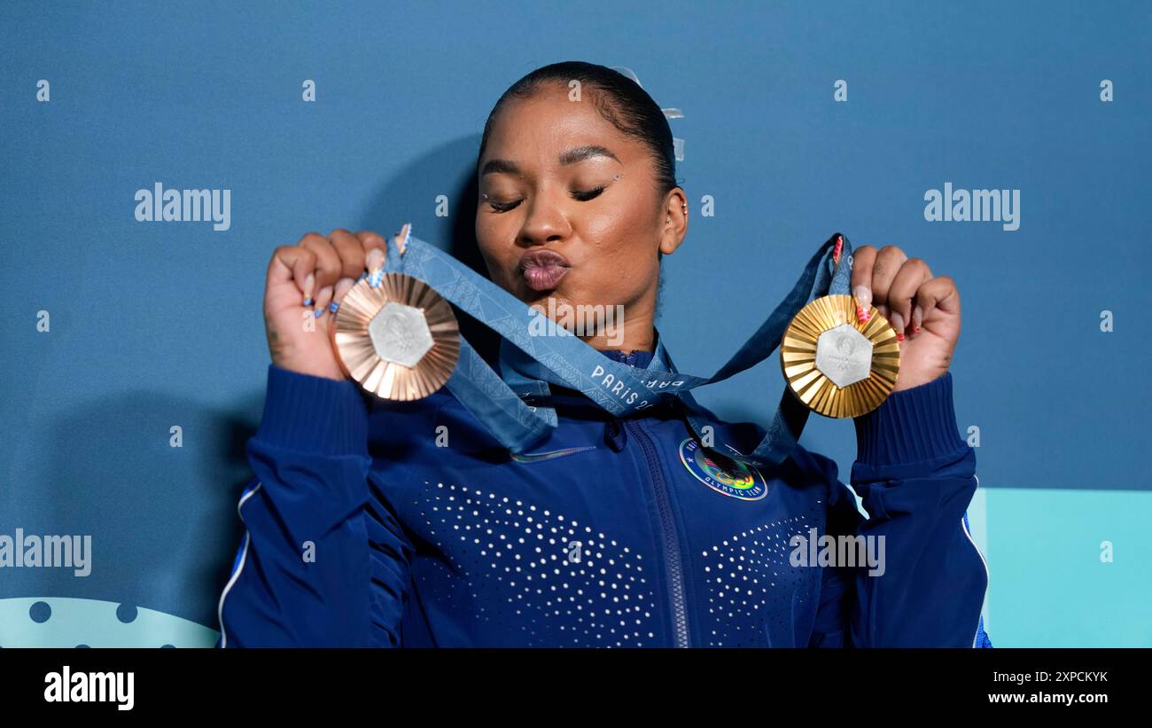 Jordan Chiles, of the United States, holds up her medals after the ...