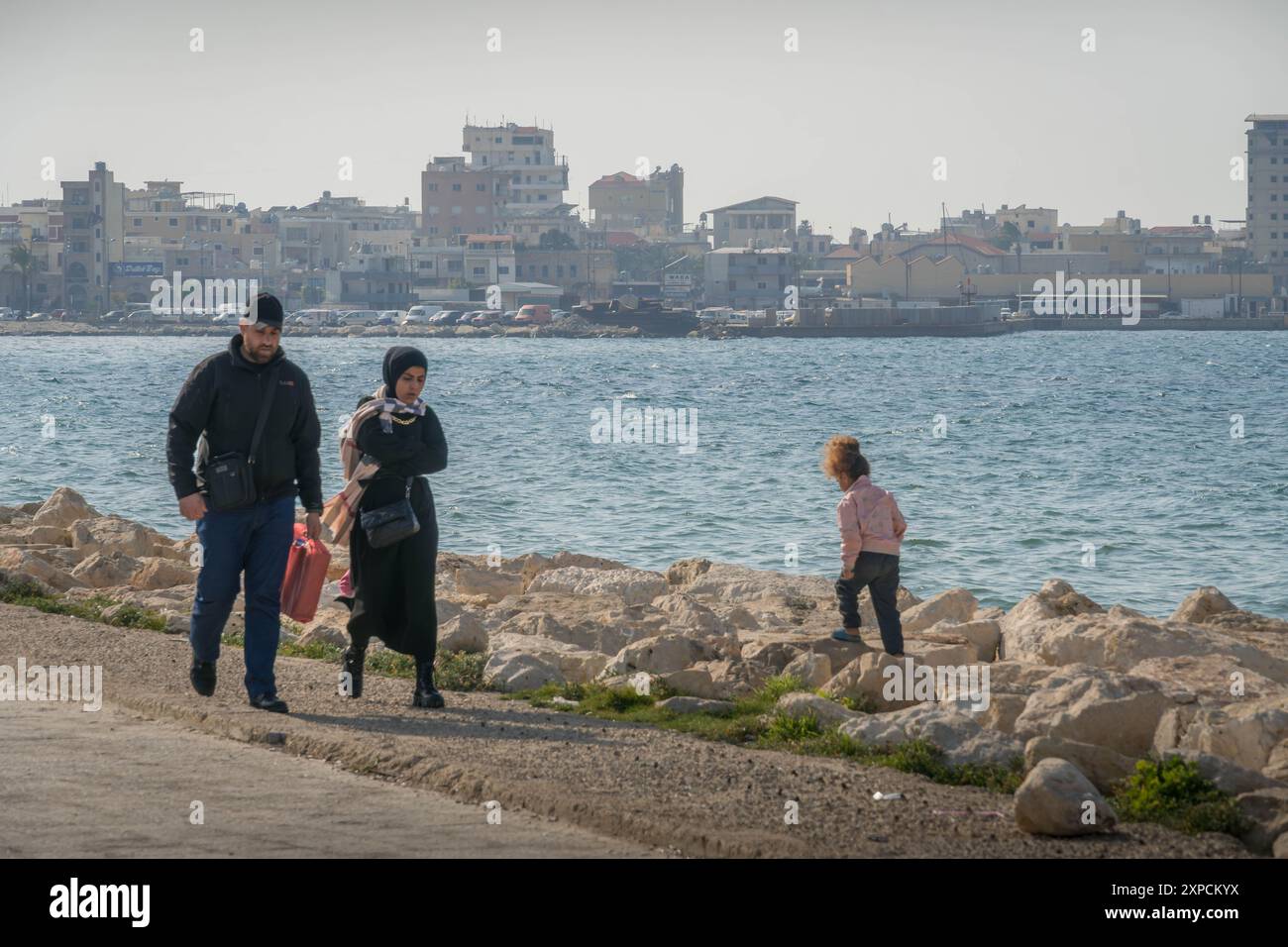 The Arab family with young kid on the waterfront of Tyre (Sour), the ...