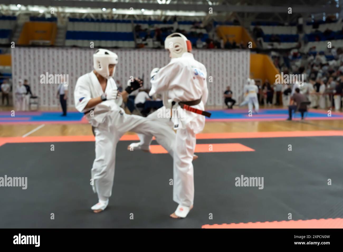 Blurred Defocused Image With Two Karate Practitioners Sparring On A