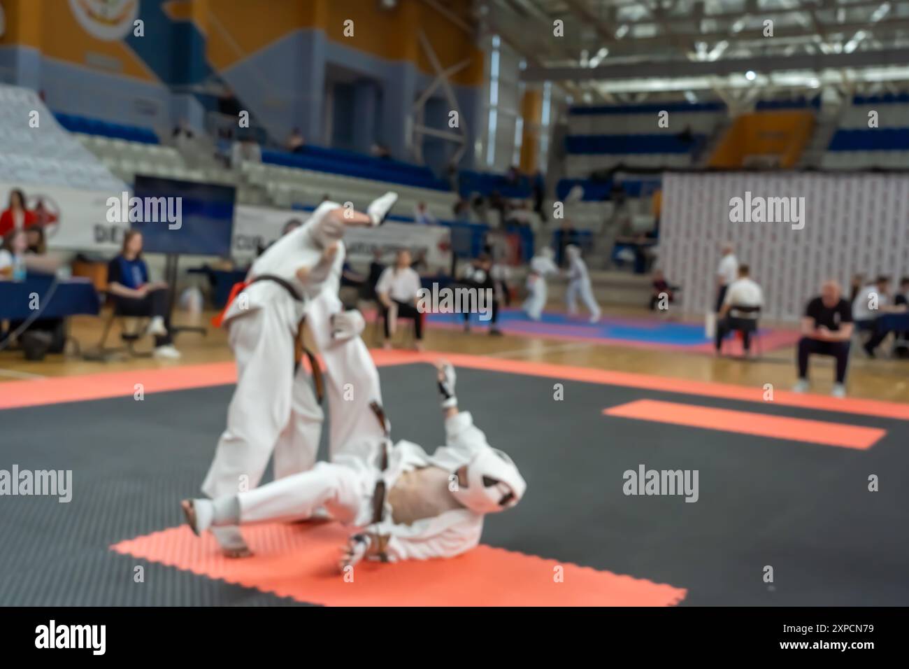 Blurred Defocused Image With Two Karate Practitioners Sparring On A